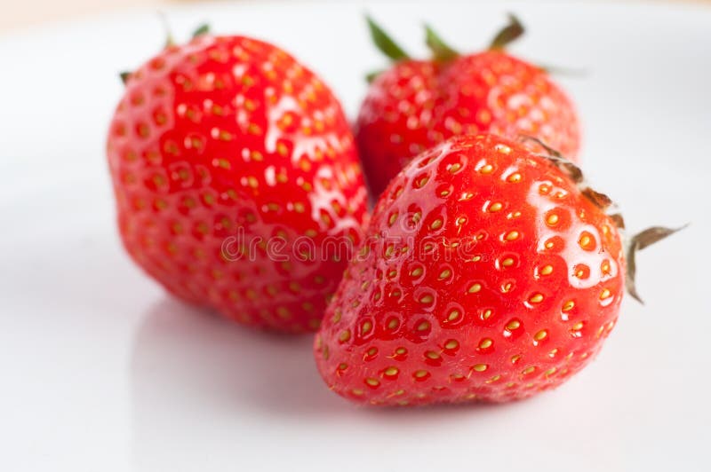 Three Strawberries stock photo. Image of macro, white - 24698572