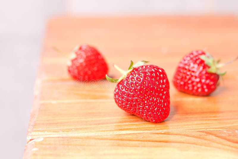 Three Strawberries on Table, Side View Stock Image - Image of organic ...
