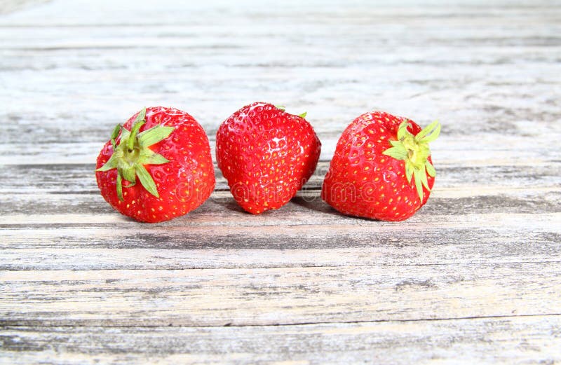 Three Strawberries on a Wooden Table Stock Photo - Image of healthy ...