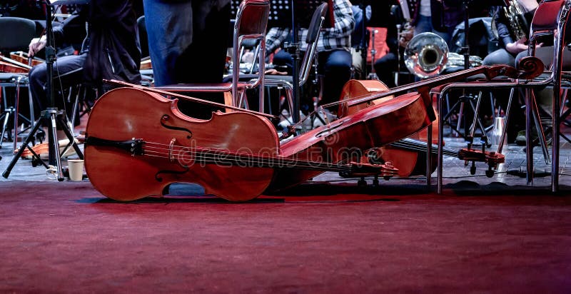 Three Stringed Musical Instruments Cello Lie on the Stage Stock Image ...