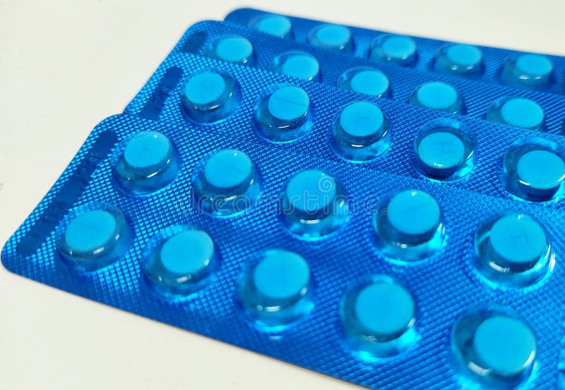 Three Strips of White Tablets in a Blue Blister Isolated on White ...