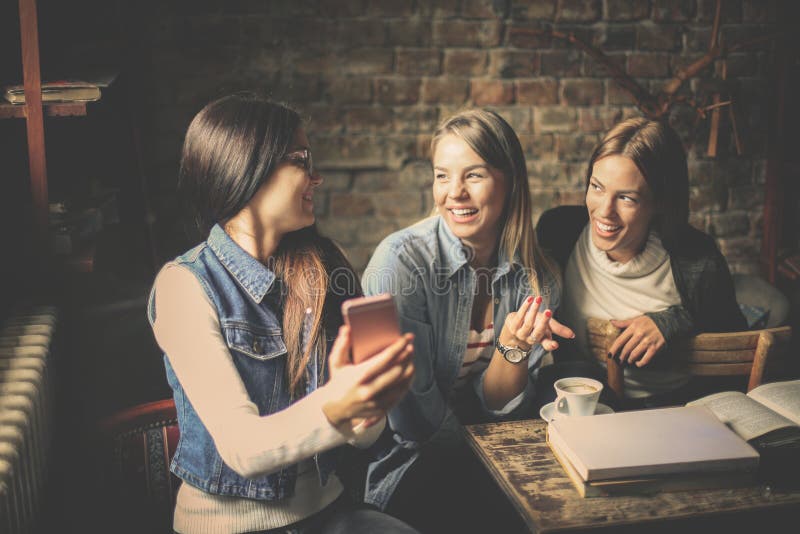 Three Students Girls Having Conversation and Using Smart Phone. Stock ...