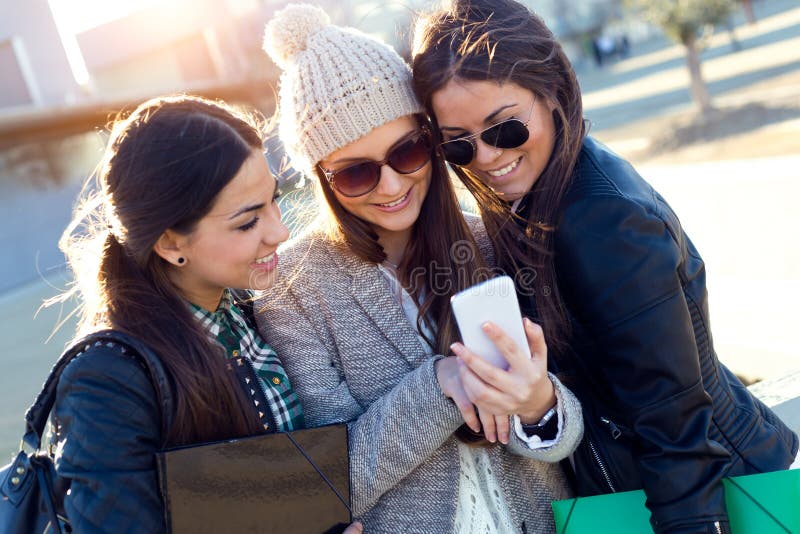 Three Students Girls Using Mobile Phone in the Campus. Stock Image ...