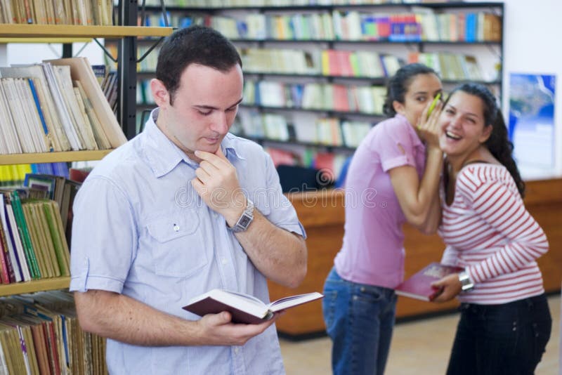 Three students in library stock image. Image of cute, concentration ...