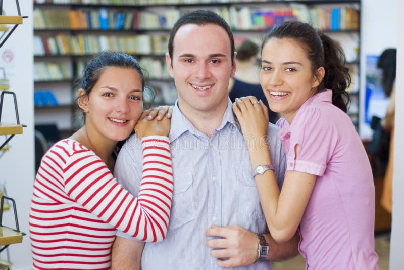 Three students in library stock image. Image of student - 6203035
