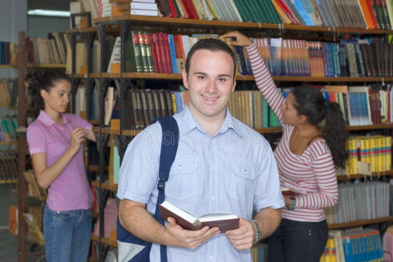 Three students in library stock image. Image of smiling - 6203203