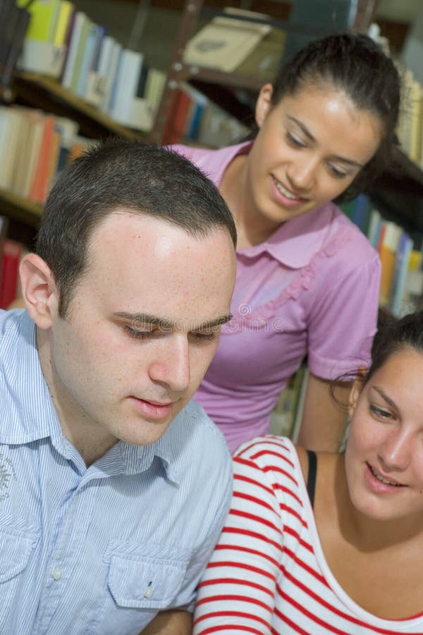 Three students in library stock photo. Image of studying - 6203192