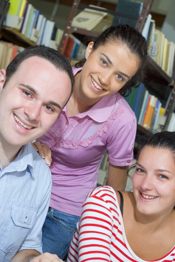 Three students in library stock photo. Image of person - 6203268