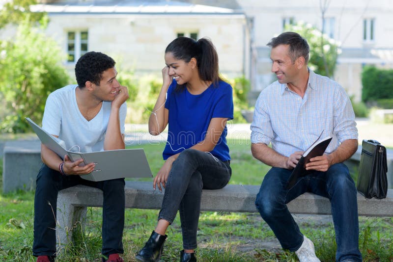 Three students outdoors stock image. Image of happy - 314280203