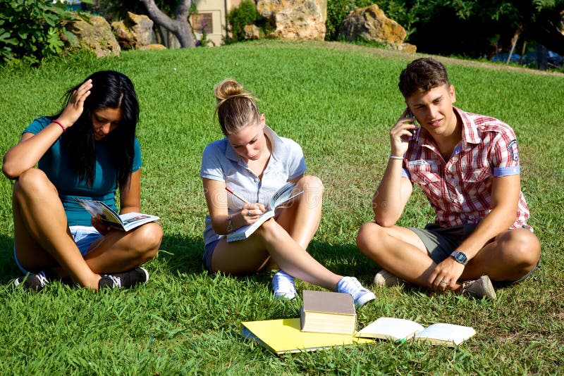 Three Students in Park Working Stock Image - Image of adult, learning ...