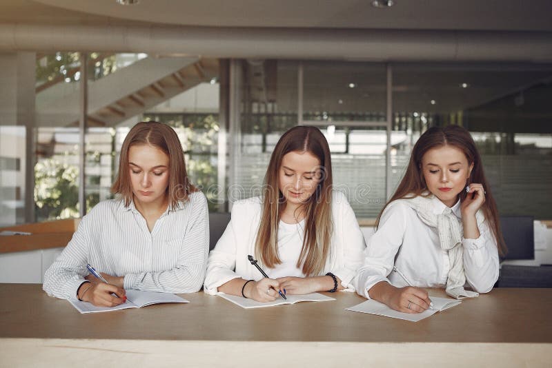 Three Students Sitting at the Table in a Class Stock Photo - Image of ...