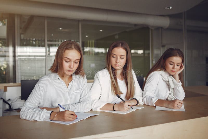 Three Students Sitting at the Table in a Class Stock Image - Image of ...