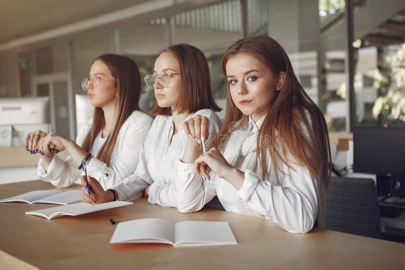 Three Students Sitting at the Table in a Class Stock Photo - Image of ...