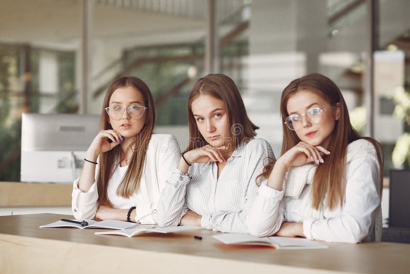 Three Students Sitting at the Table in a Class Stock Photo - Image of ...