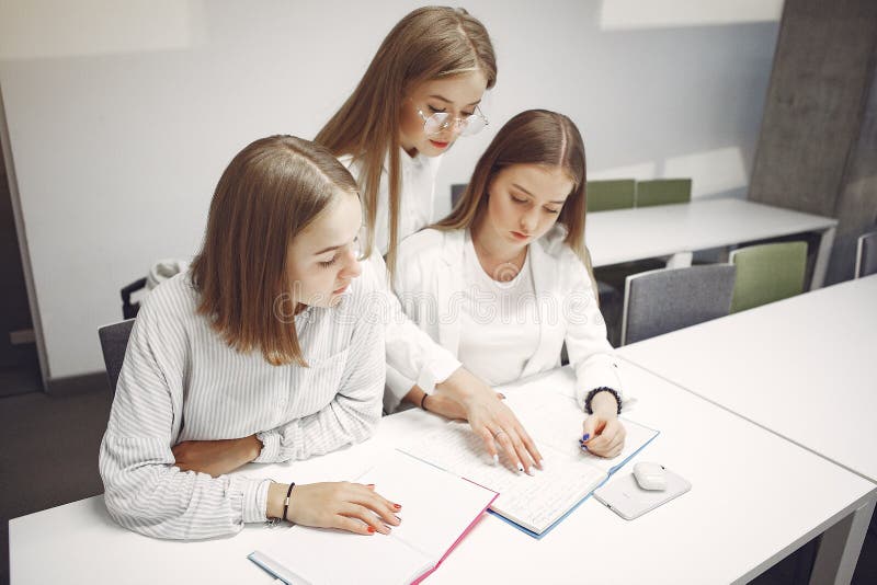 Three Students Sitting at the Table in a Class Stock Photo - Image of ...