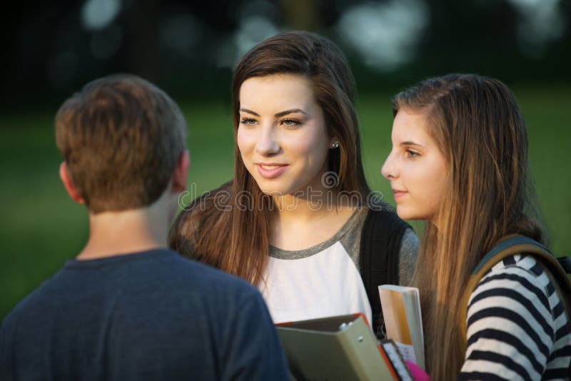 Three Students Talking Outdoors Stock Photo - Image of chatting ...