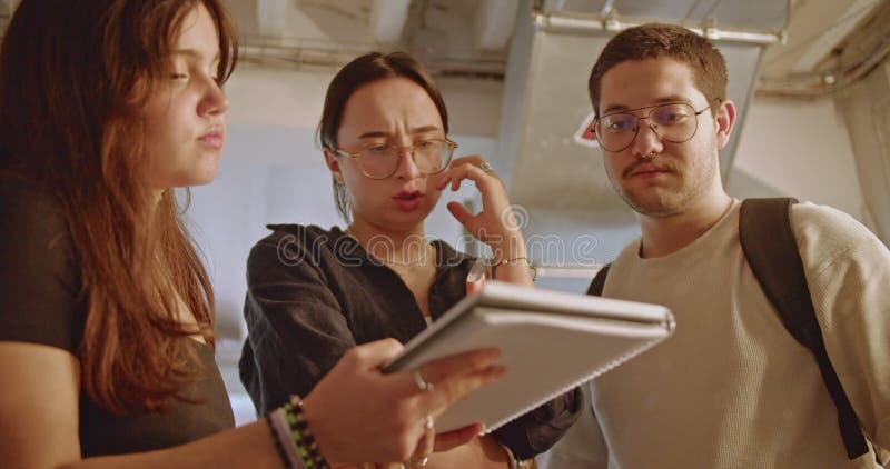 Students Collaborating on a Project: Three Young Adults Working ...