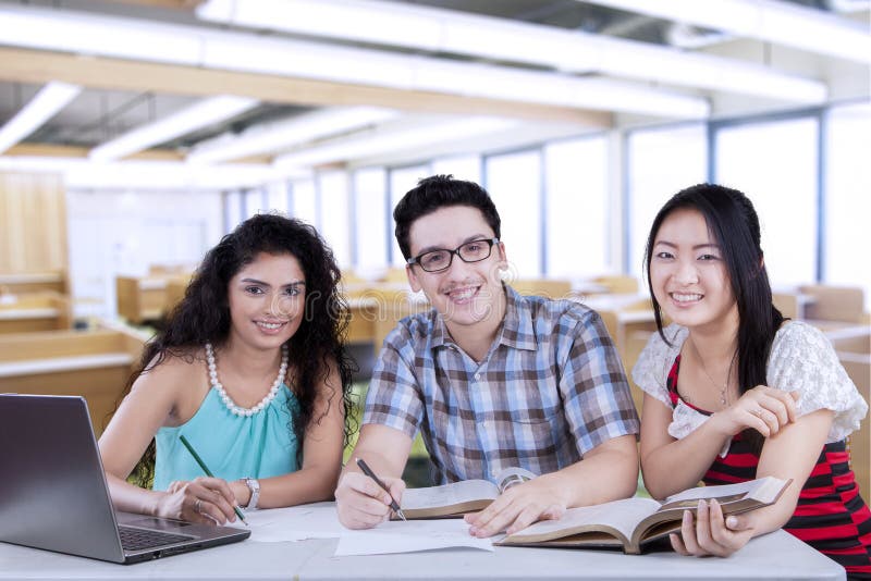 Three Students Writing in the Class Stock Image - Image of eastern ...
