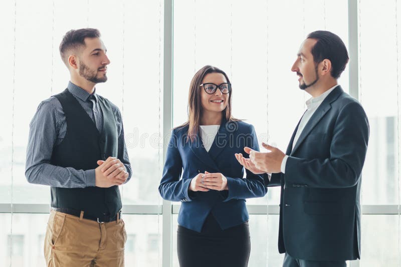 Three Successful Business People Talking in Office. Stock Image - Image ...