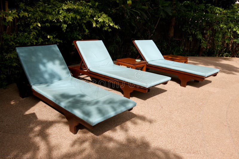 Three Sun Beds in Trees Shadow (in HiRes) Stock Photo - Image of ...