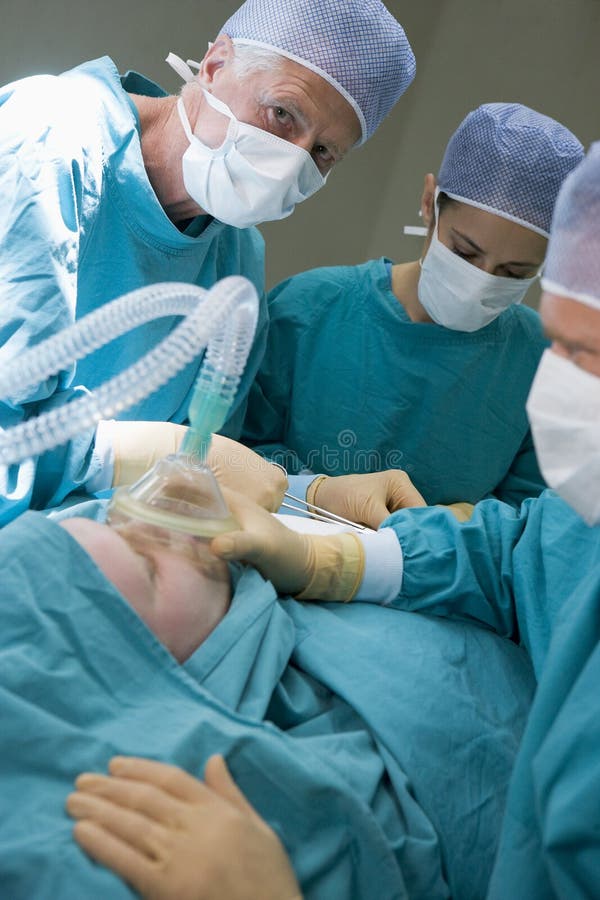 Three Surgeons Operating on a Patient Stock Image - Image of medicine ...