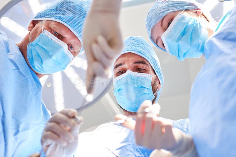 Three Surgeons in the Operating Room during a Surgical Procedure Stock ...