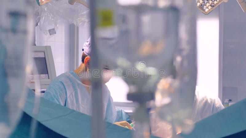 Three Surgeons, a Man and a Woman, Perform Surgery in the Operating ...