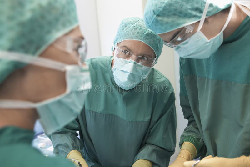 Multi-ethnic Surgeons during a Surgery Stock Image - Image of ailment ...