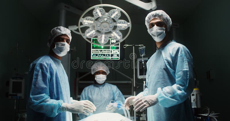 A Team of Surgeons Perform an Operation in a Bright Operating Room ...