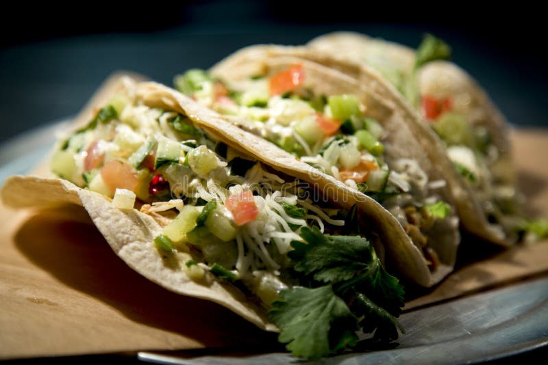Three Tacos On A Plate Next To A Cell Phone Stock Image - Image of ...
