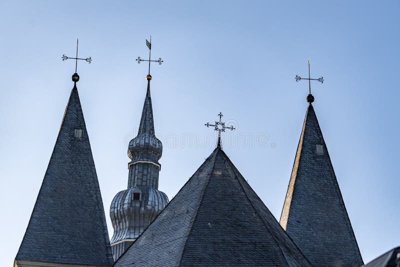 Three Tall Buildings with a Cross on Top of the Middle One Stock Photo ...