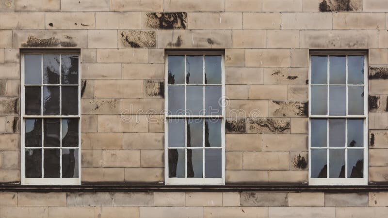 Three Tall, Rectangular Windows Set into a Weathered Stone Wall Stock ...