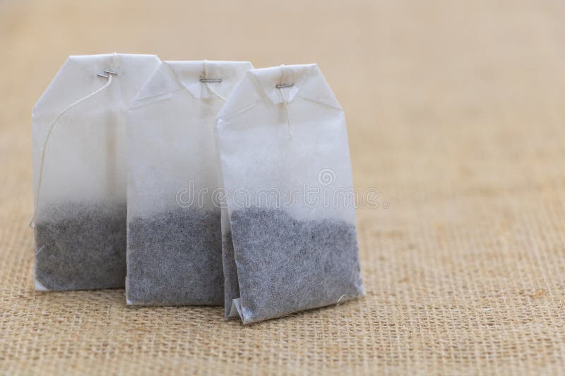 Three Tea Bags on the Table, Close-up of Paper Tea Bags with Black and ...