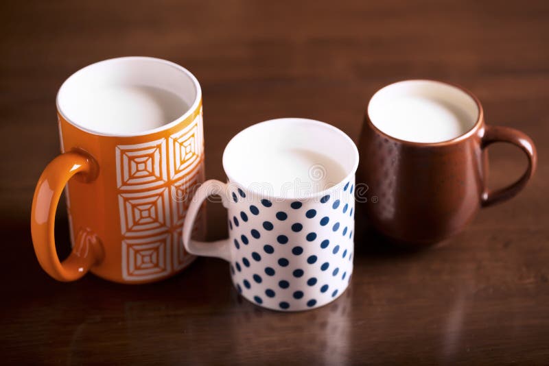 Three tea cups with milk stock image. Image of dinner - 53663049
