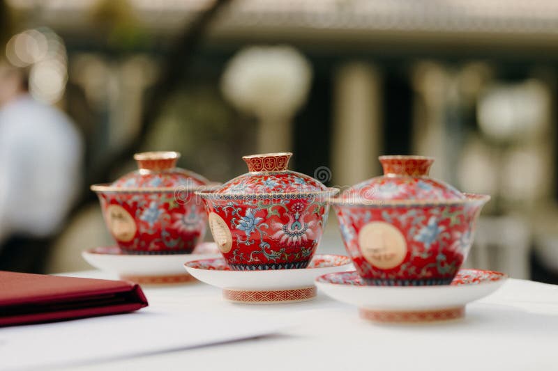 Three Tea Cups Sit on Top of a Table with a Menu on the Side Stock ...
