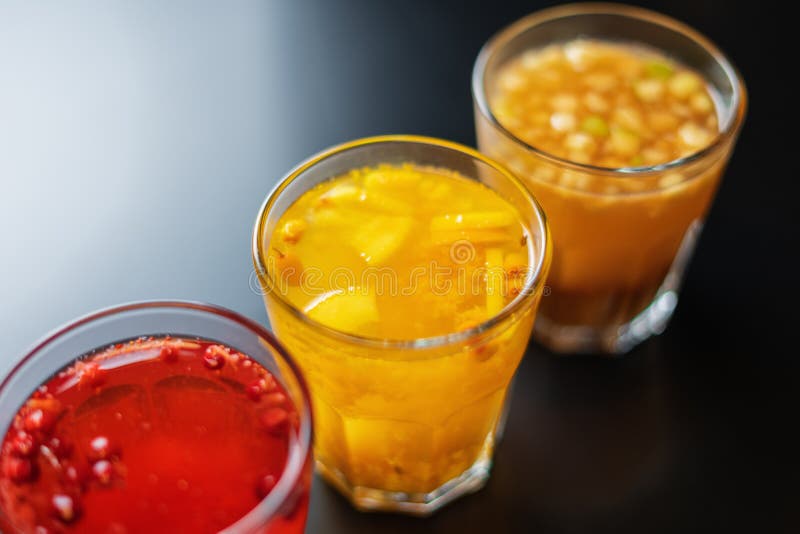 Three Teas from Different Berries and Fruits on a Black Table in a Cafe ...