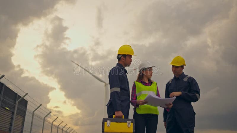 Three Technician Engineer in Uniform with Standing and Checking Wind ...