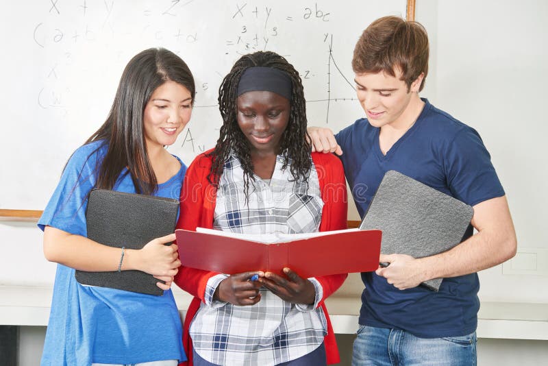 Three teenage students stock image. Image of interracial - 64498945