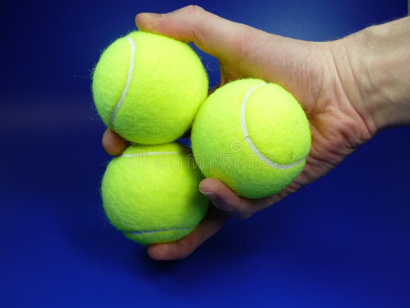 Three Tennis Balls Lie On A Tennis Racket Strings. Over Green La Stock ...
