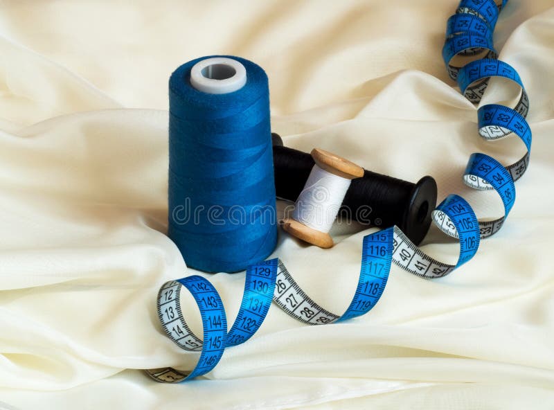 Three Threads of Different Colors and Blue Twisted Tape Measure Stock ...