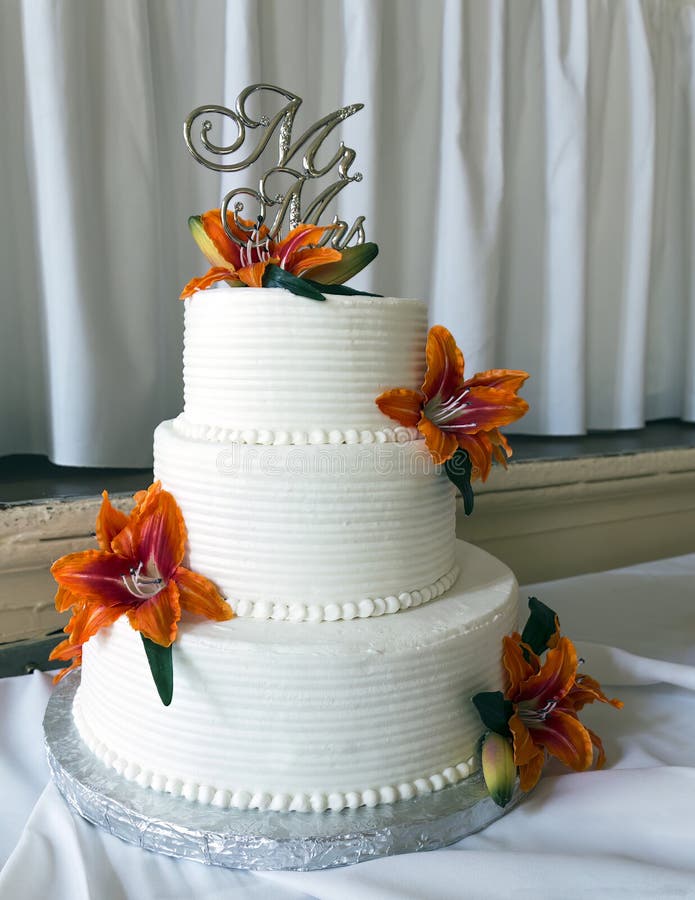 Wedding Cake with Orange Lilies and Mr and Mrs Cake Topper Stock Image ...