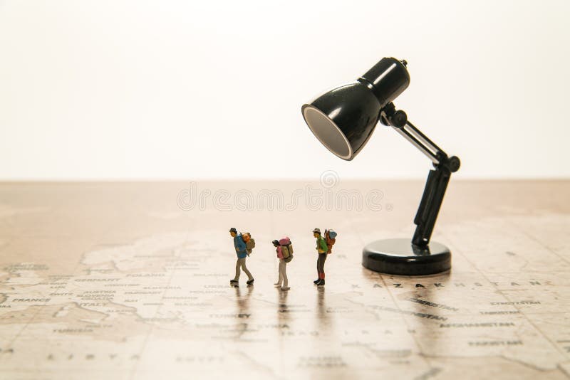 Three Tiny Human Models Walk on World Map with Lamp Stock Image - Image ...