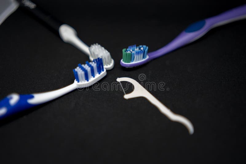 Three Toothbrushes and a Dental Floss Instrument Stock Photo - Image of ...