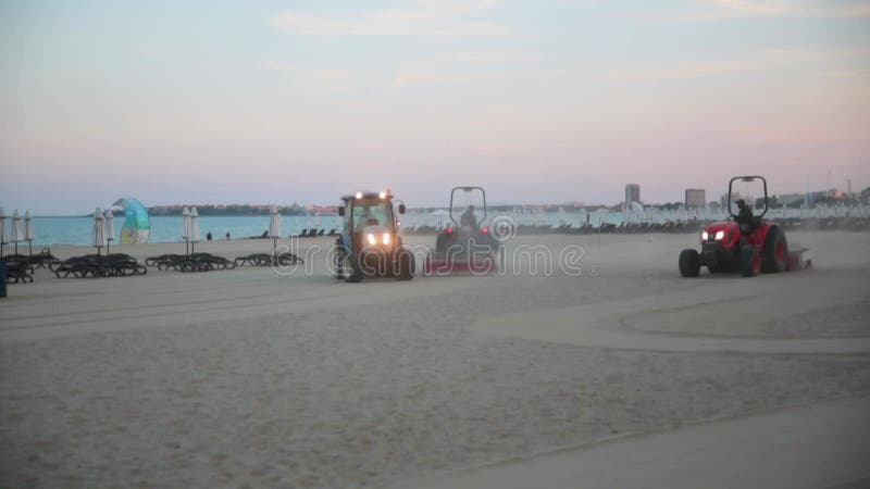 Three Tractors Cleaning an Empty Beach in the Evening Stock Footage ...