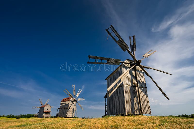 Three Traditional Windmills on the Countryside at Sunset Stock Image ...
