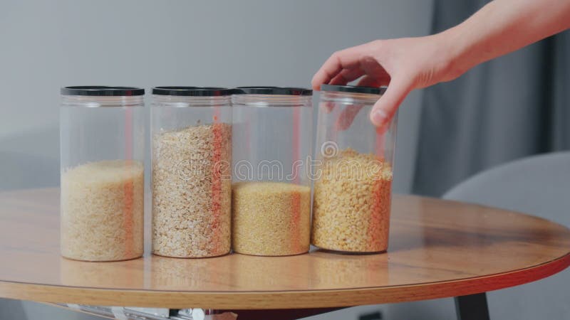 Three Transparent Containers Filled with Various Types of Rice Sit on a ...