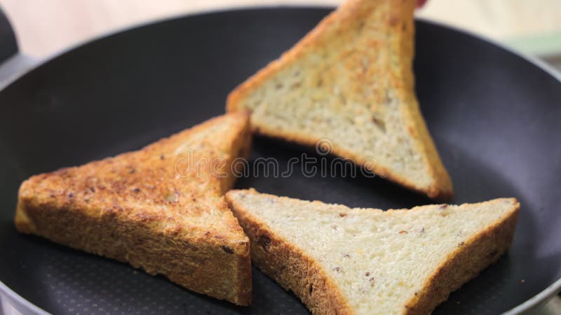 Three Triangular Sandwich Slices Placed in a Non-stick Frying Pan ...