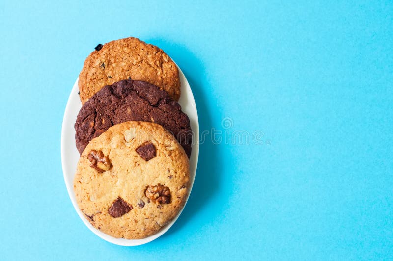 Three Types of Cookies in a Plate on a Blue Background Stock Image ...