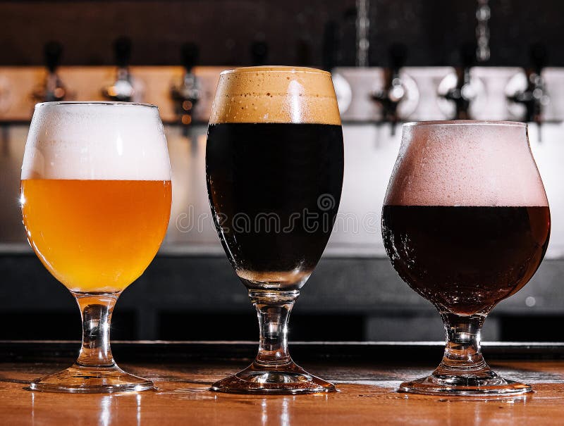 Three Types of Craft Beer in Glasses on Table in Pub Interior Stock ...