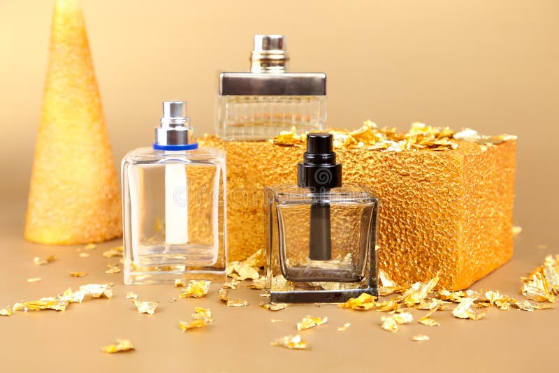 Three Unbranded Perfume Spray Bottles, Pieces of Gold Paper and Golden ...